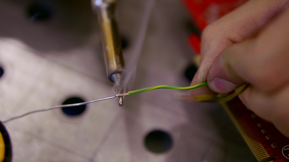 Shot of a Metal Wire Held in the Hands of Welders a Man Tears the Wire ...