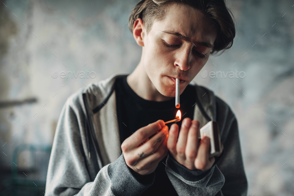 Male drug addict light a cigarette Stock Photo by NomadSoul1 | PhotoDune