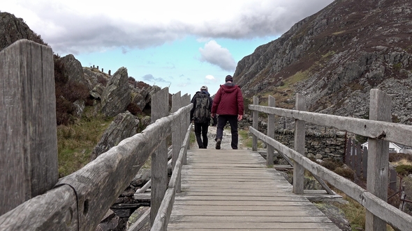 Hiker Walking Over the Wooden Bridge at the Waterfall, Stock Footage