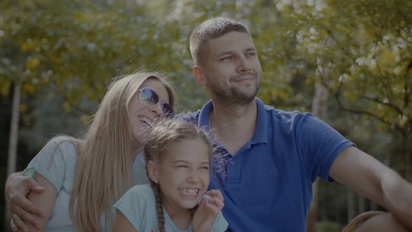 Radiant Family with Daughter Relaxing in Park, Stock Footage | VideoHive