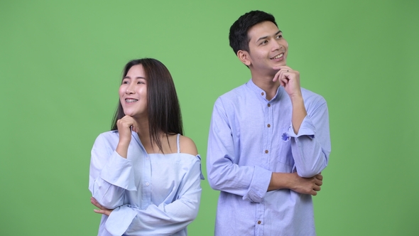 Young Happy Asian Business Couple Thinking Together, Stock Footage