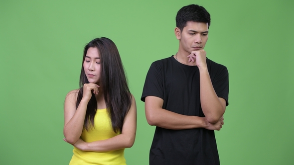 Young Sad Asian Couple Thinking Together, Stock Footage | VideoHive