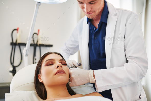 Male doctor doing botox injections on a young female client Stock Photo ...