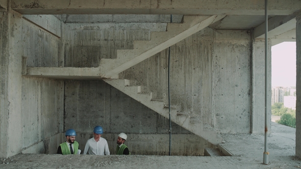Two Expert Engineers and Construction Supervisor Lift Up the Stairs of ...