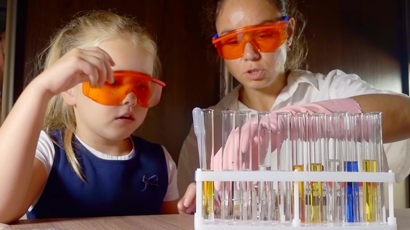Concept: Teacher Showing a Student How To Conduct Experiment, Stock Footage