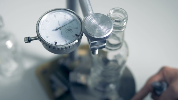 Factory Worker Uses Special Device To Checks Bottle's Quality, Stock ...