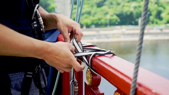 Young Man Bind a Rope on a Bridge, Stock Footage | VideoHive