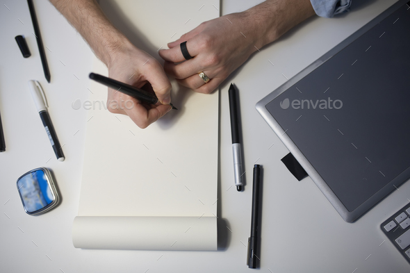 Designer hands drawing design project. Stock Photo by arthurhidden