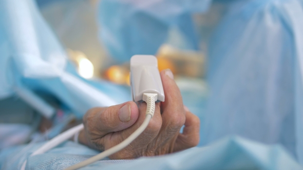 Human Hand with an Operative Sensor Attached To a Finger, Stock Footage