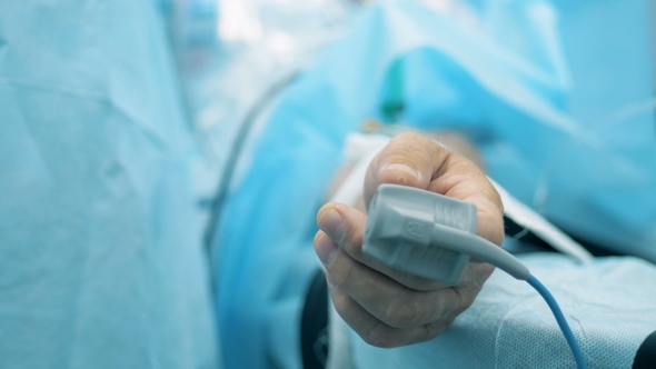 of Patient's Hand During Surgery with a Sensor Attached To It, Stock ...