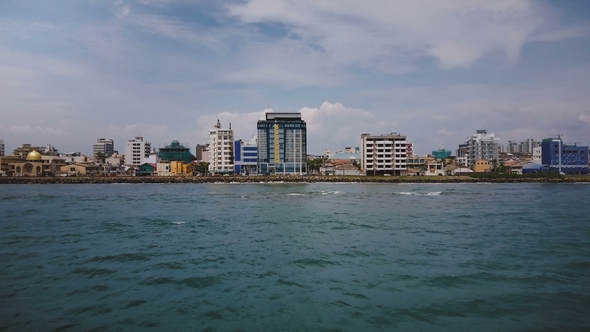 Drone Flying Low Above the Ocean Water Towards Colombo City, Stock Footage