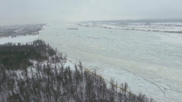 Aerial View of Frozen River Surrounded By Forest in Winter Season ...