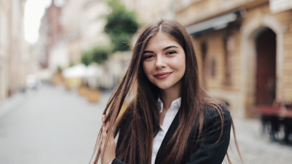 Young Business Woman Walks Down the Central City Street, Turns and ...