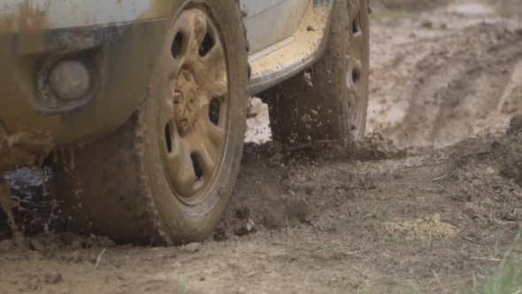Powerful Towed Off-road Vehicle on Dirty Rural Road After Rain in Bad ...