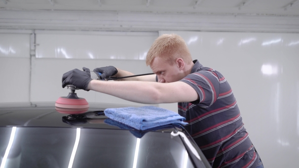 Worker Is Sanding Surface of Roof of Black Car in Auto-service After ...