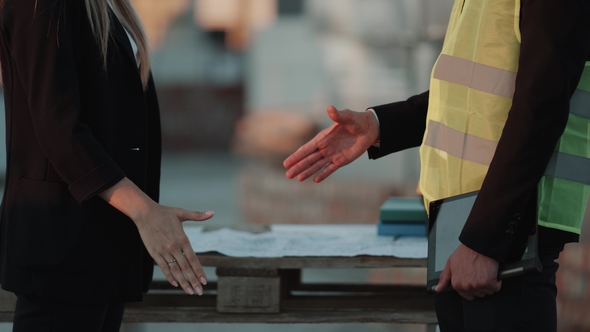 Construction Site Two Business Partners Making a Deal Holding Hands ...