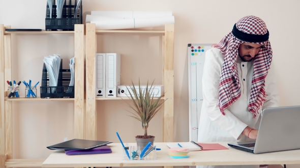Modern Middle Eastern Man in Ethnic Costume Working in the Office at ...