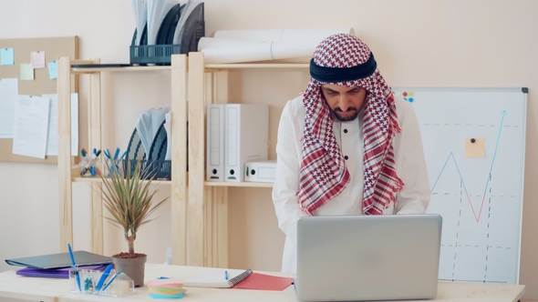 Modern Middle Eastern Man in Ethnic Costume Working in the Office at ...
