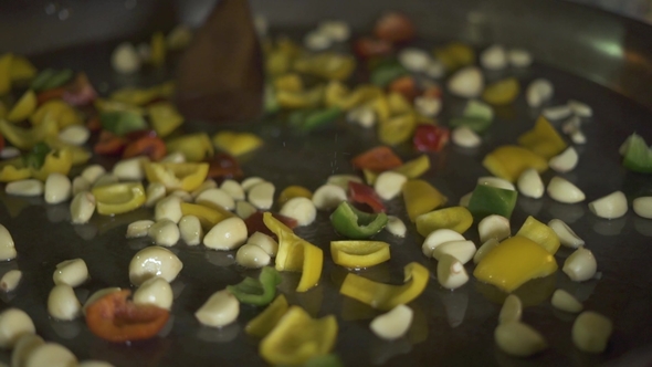 Chef Cooking Garlic and Peppers While Preparing Food in Restaurant ...