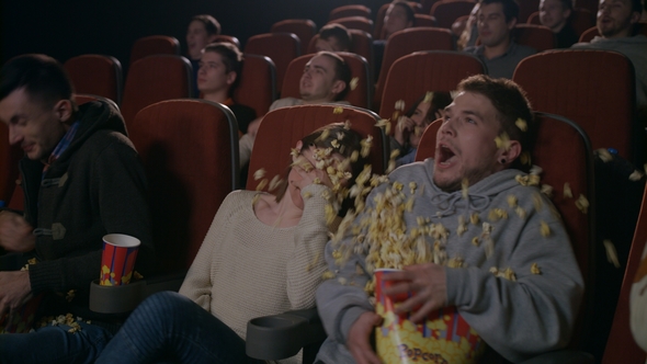 Young Guy Scared While Watching Horror Film in Movie Theatre, Stock Footage