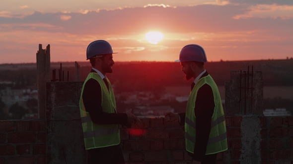 Construction Site on Rooftop , Two Workers Have Fun Time Together ...