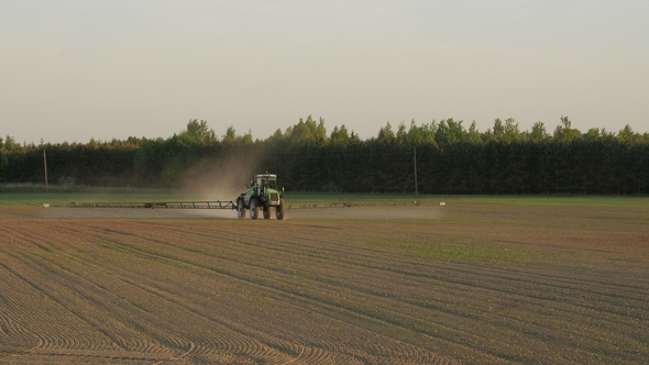Tractor Spray Field with Chemicals for Crop Plants Protection From Weed ...