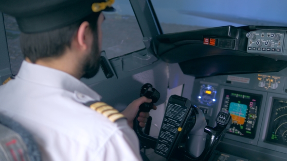 Back View of a Male Pilot Managing an Aircraft, Stock Footage | VideoHive