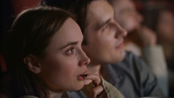 Young Couple Enjoying Film in Cinema Embracing. Love Couple Watching ...