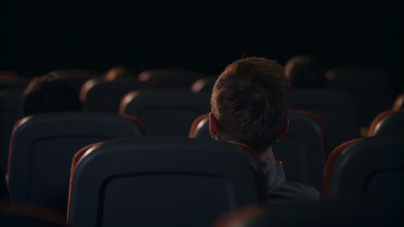 People Sitting in Cinema. Back View. Napes of Spectators Sitting in ...