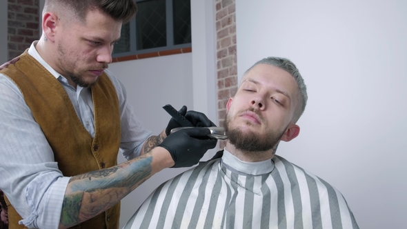 Shaving of Beard. Barber Cutting Men's Face Hair with Beard Trimmer at ...