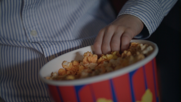 Child Hand Taking Popcorn From Paper Box at Cinema. Kids Take Caramel ...