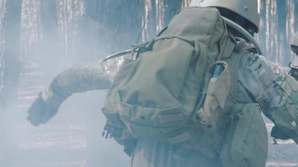 The Soldier in a Panic Hides Behind a Tree During Fight in Forest ...