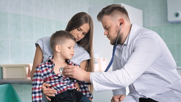 Physician in White Lab Coat Examines Rib Cage of Sick Child Using ...