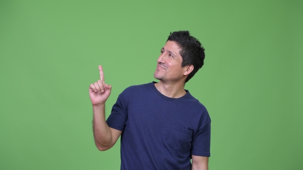 Hispanic Man Thinking While Pointing Up, Stock Footage | VideoHive