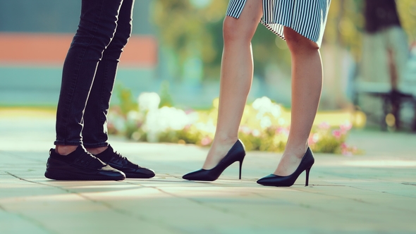 Two Pairs of Legs Stand with Each Other in the Park, Stock Footage