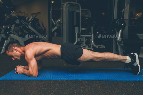 man doing plank position at the gym Stock Photo by Vladdeep | PhotoDune