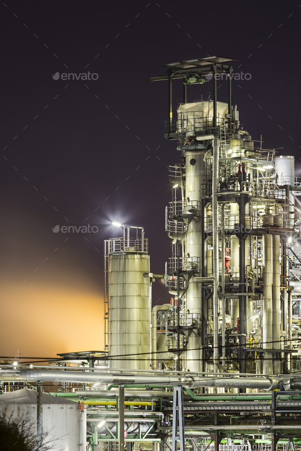 Refinery Towers And Steam At Night Stock Photo by IndustryAndTravel