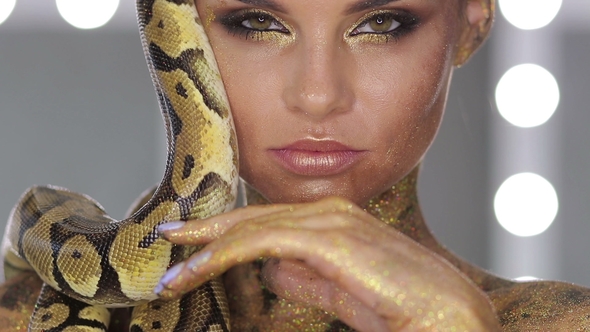 Woman with Body Art Holding Snake, Stock Footage | VideoHive