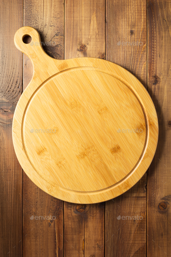 cutting board at wooden table Stock Photo by seregam | PhotoDune