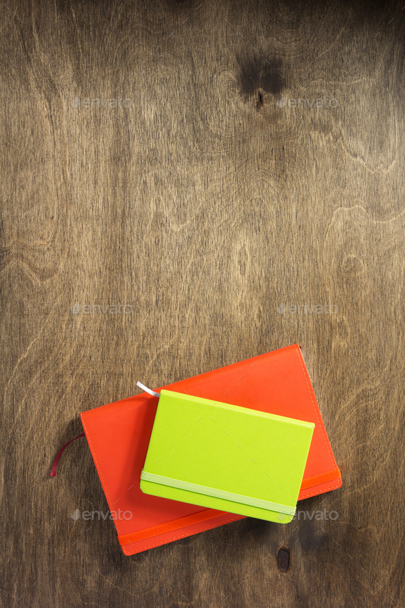 colorful notebook at wooden background Stock Photo by seregam | PhotoDune