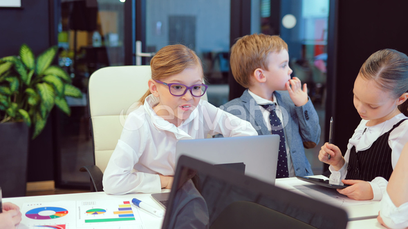 Group of Business Children Near the Table Are Discussing the Company's ...