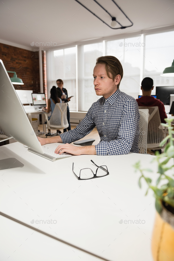 Male executive working on computer in office Stock Photo by Wavebreakmedia