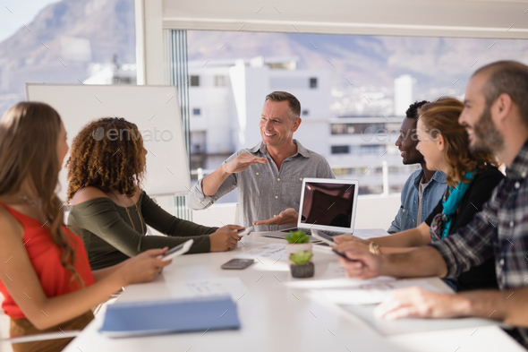 Executive having discussion in conference room Stock Photo by ...