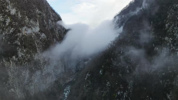 Drone View of the Dense Fog Creeping Along the High Cliffs in the River ...