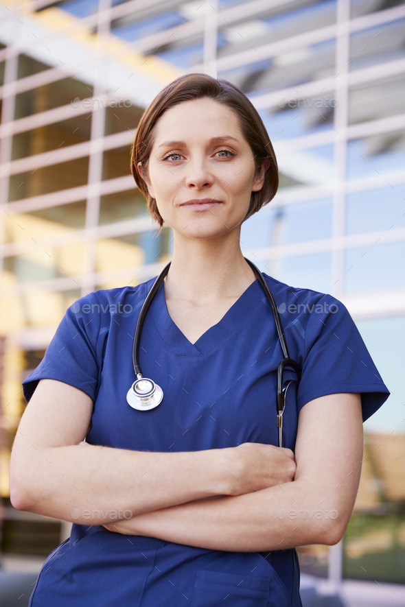 Smiling white female healthcare worker outdoors, vertical Stock Photo ...