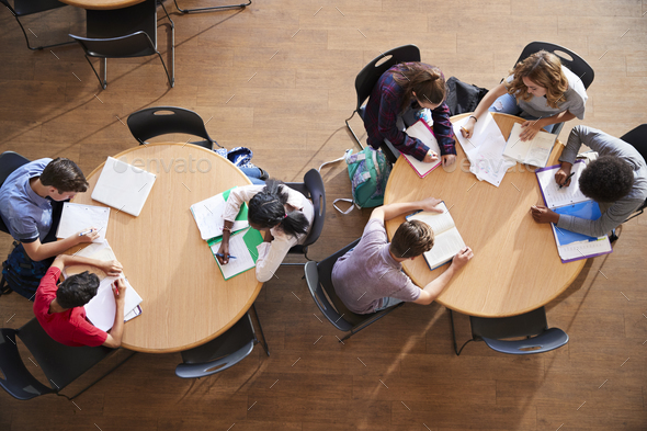 Overhead Shot Of High School Pupils In Group Study Around Tables Stock ...