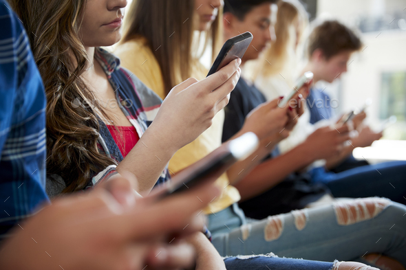 Close Up Of A Line Of High School Students Using Mobile Phones Stock ...