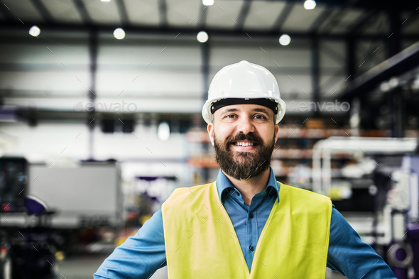 A portrait of an industrial man engineer in a factory. Stock Photo by ...