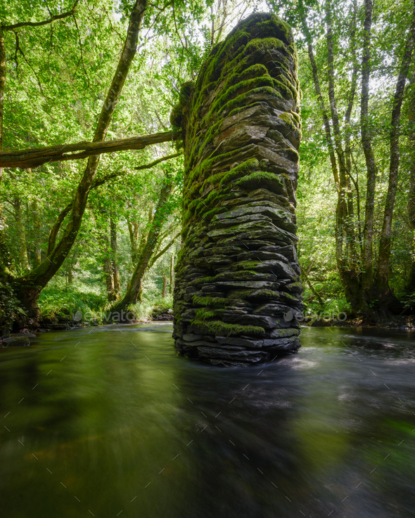 Stone pillar of an old medieval bridge Stock Photo by luisvilanova