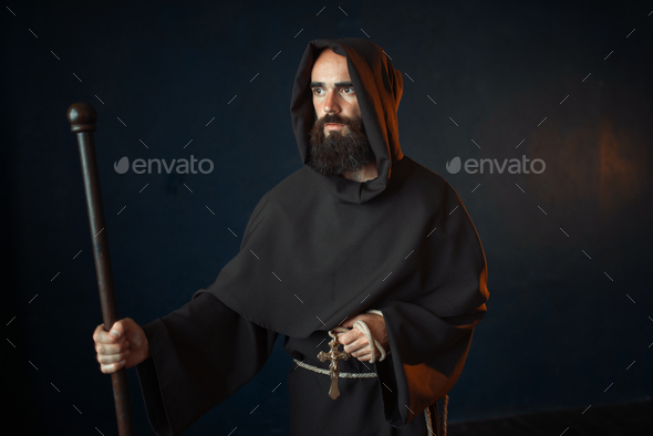 Medieval monk with wooden stick and cross in hands Stock Photo by ...